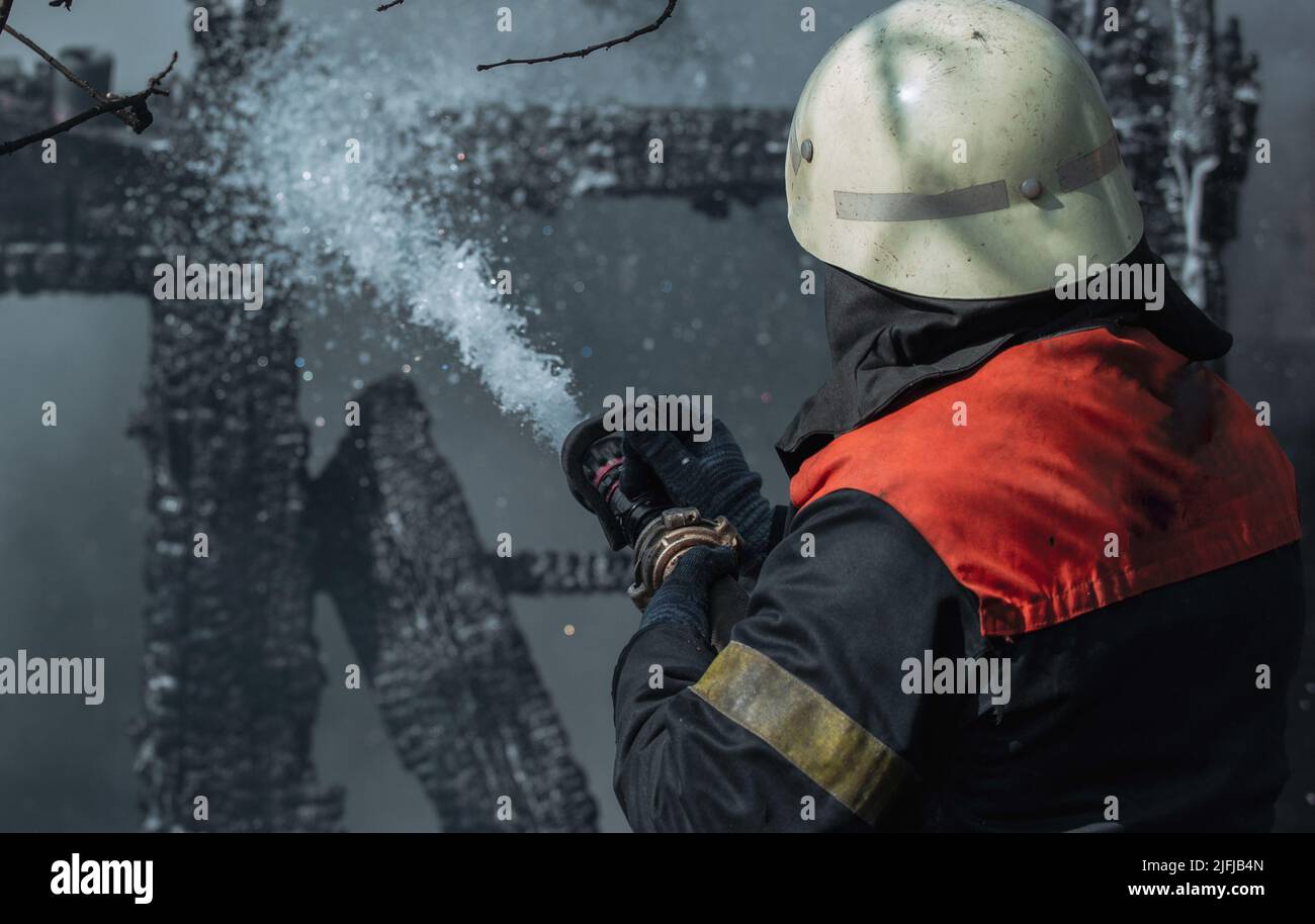 Brave firefighter saving burning building. Firefighter work concept ...