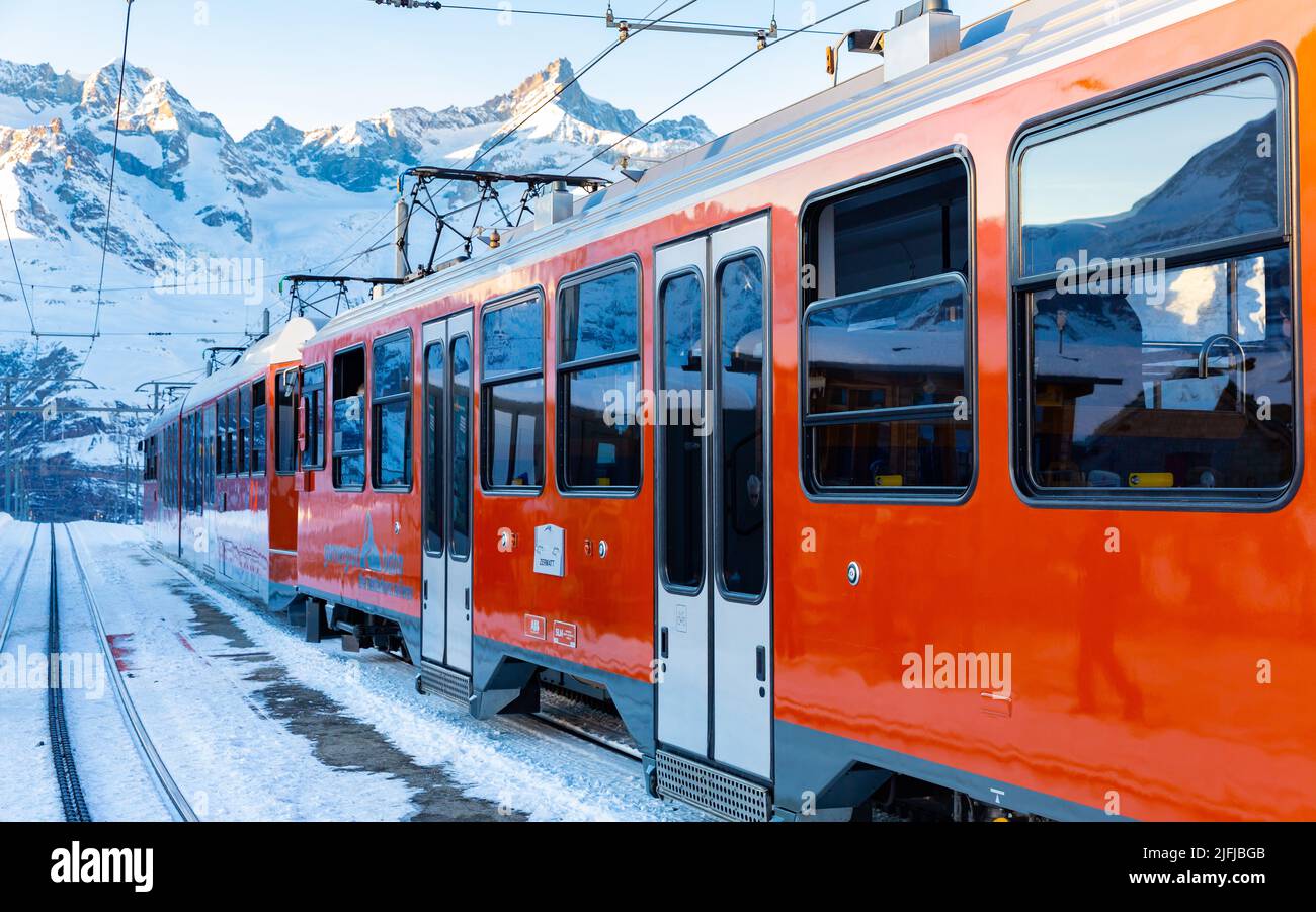 Train on mountain railway at Swiss Alps Stock Photo - Alamy