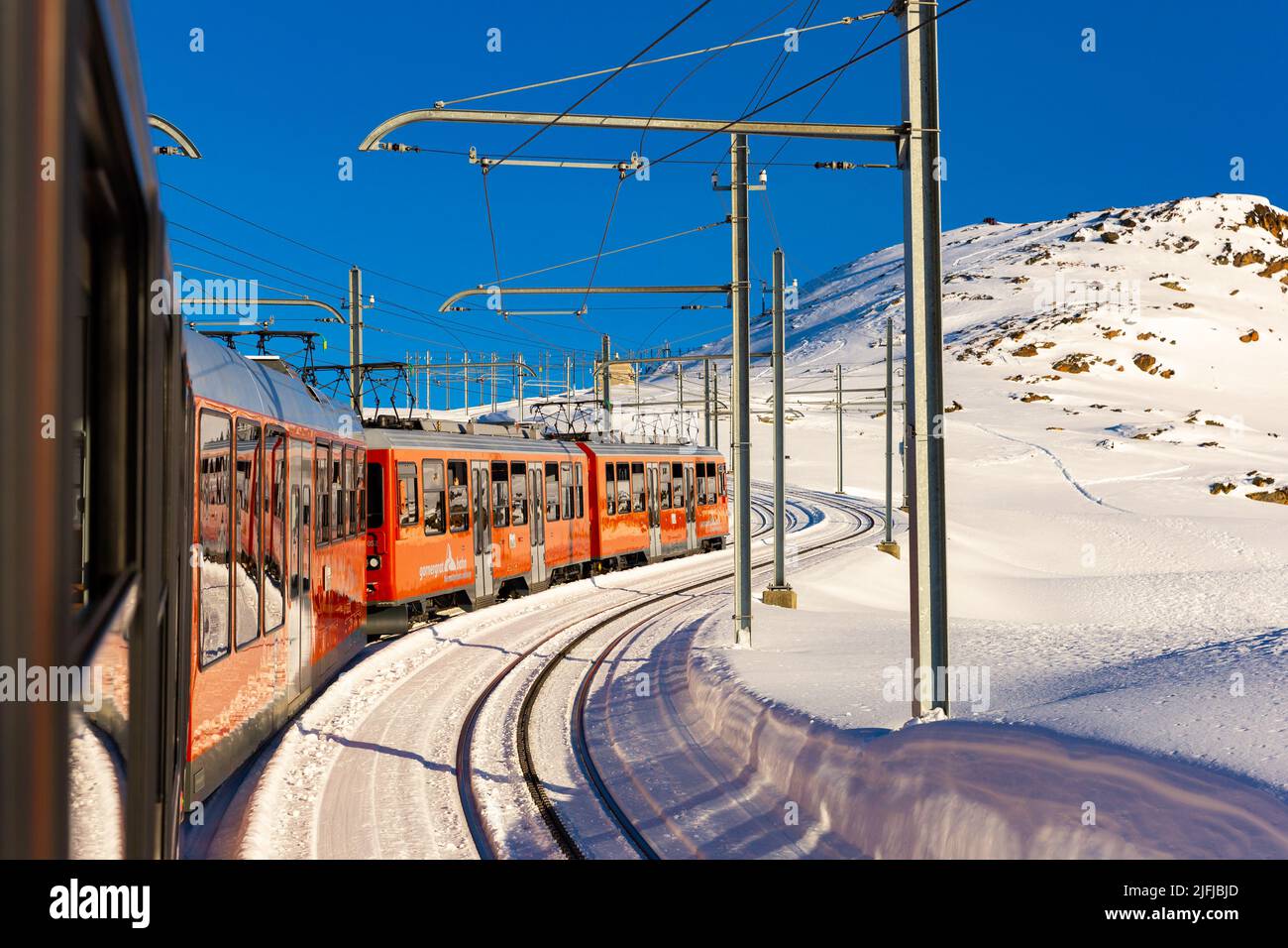 Train on mountain railway at Swiss Alps Stock Photo - Alamy