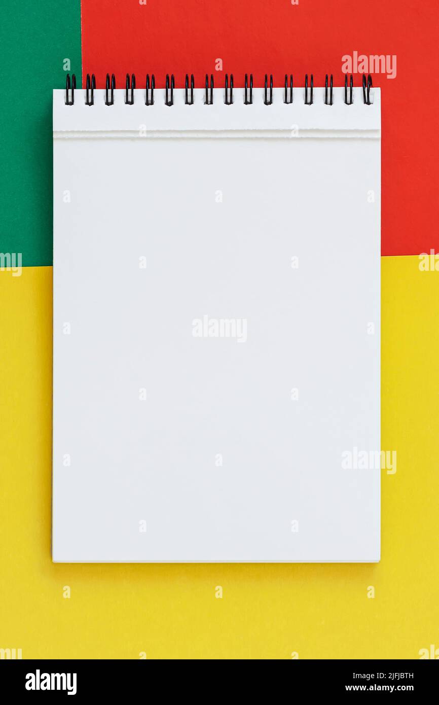 Open spiral notepad on vertical bright background. Flat lay with copy ...