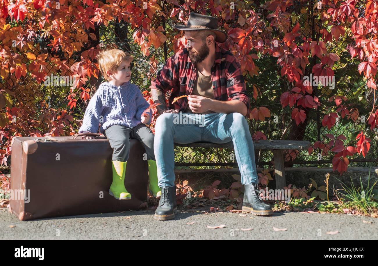 Cute little boy with his father during stroll in the forest. Dad and ...