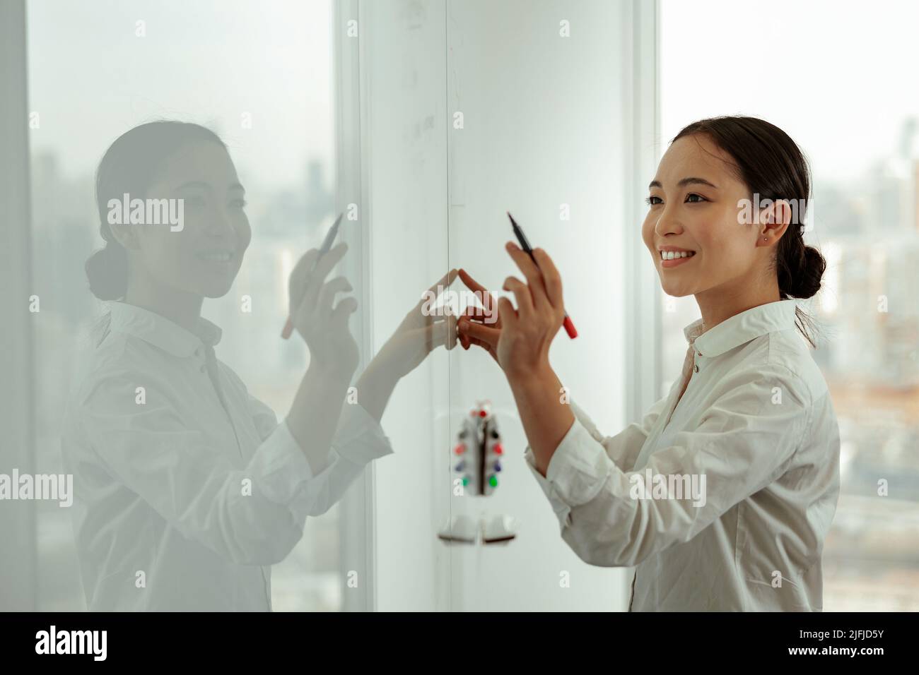Smart asian business woman write project plan on flipboard during ...