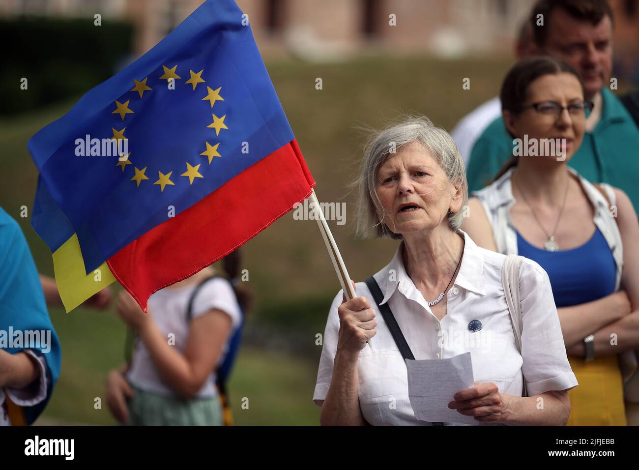 Woman holding European Union, Polish and Ukraine flags during the ...