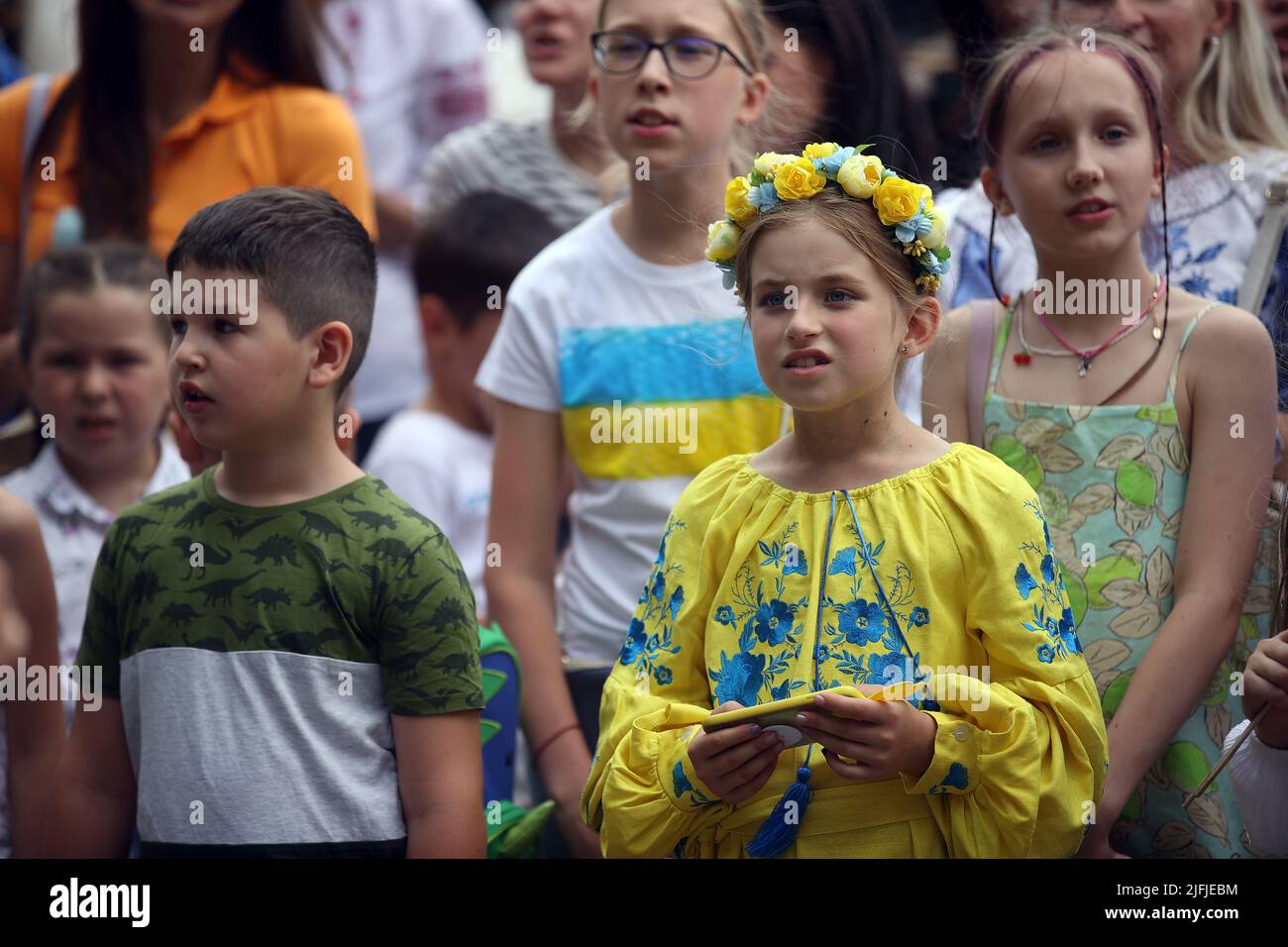 Children wearing yellow and blue, colours of the Ukrainian flag ...