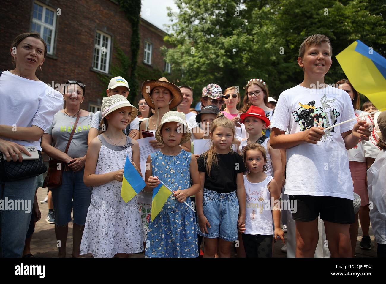 Children holding Ukrainian flags, sing during the record breaking ...