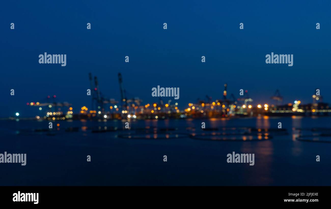 Blurred industry background with defocused cargo dock terminal in sea ...