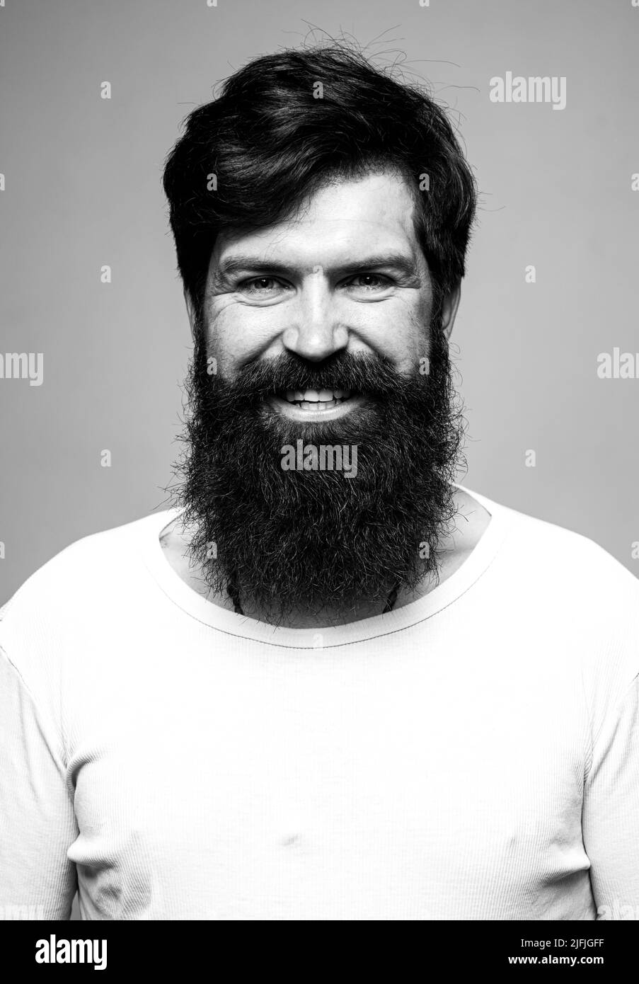 Happy man smile face. Handsome smiling young guy in studio on gray dark ...
