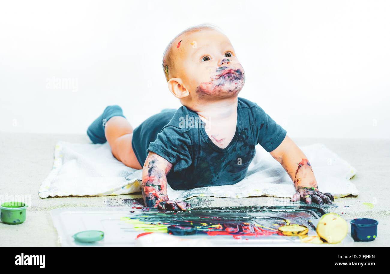 Baby playing with paints. Beautiful happy child. Lifestyle childhood ...