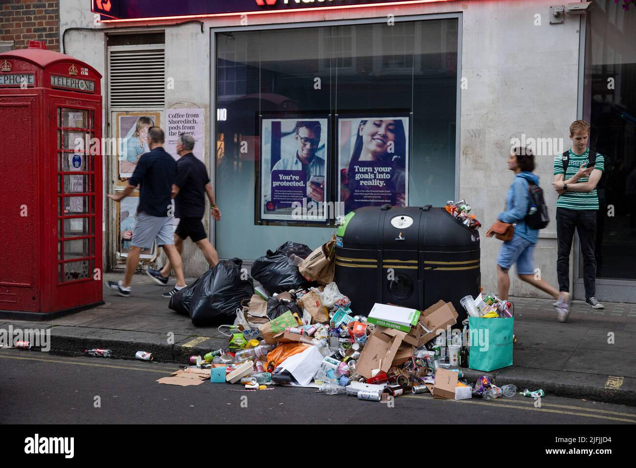 London, UK. 02nd July, 2022. Trash are seen overflowing from the bin in ...