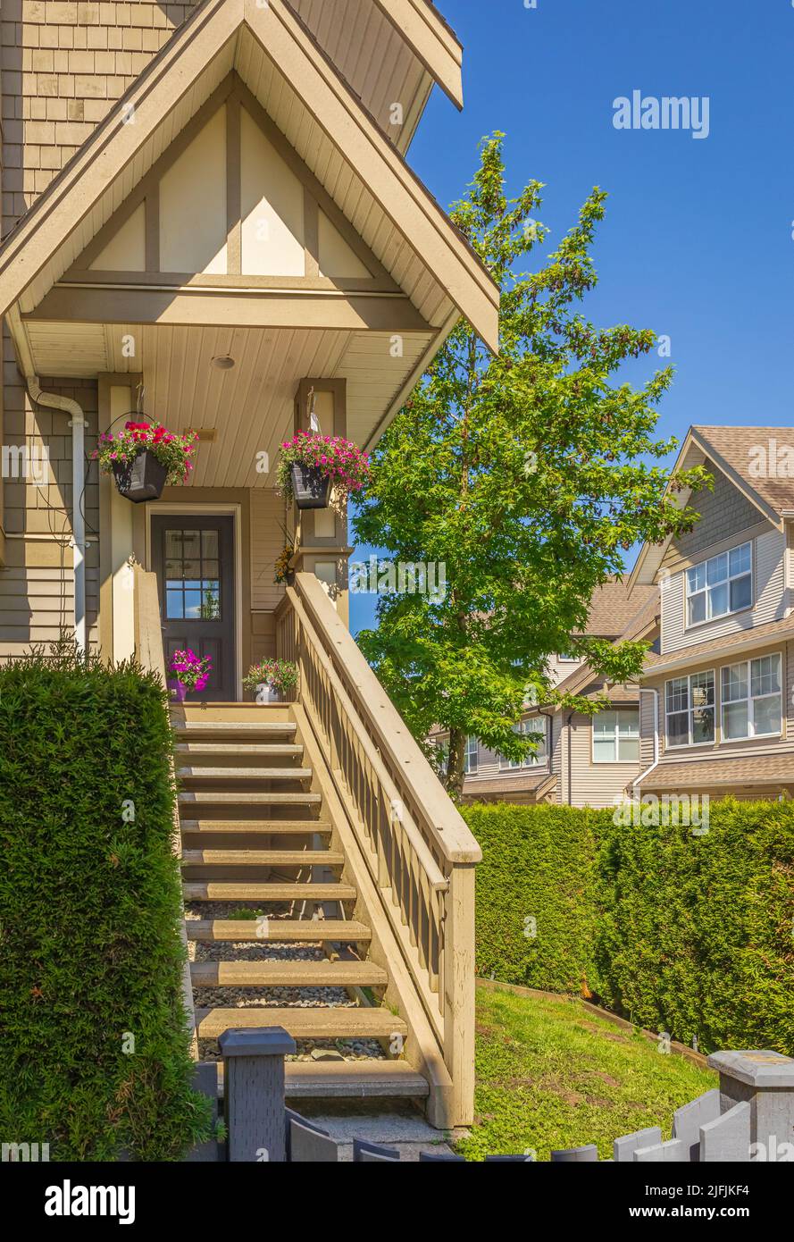 Entrance to a home through a beautiful garden with flowers. Plants and ...