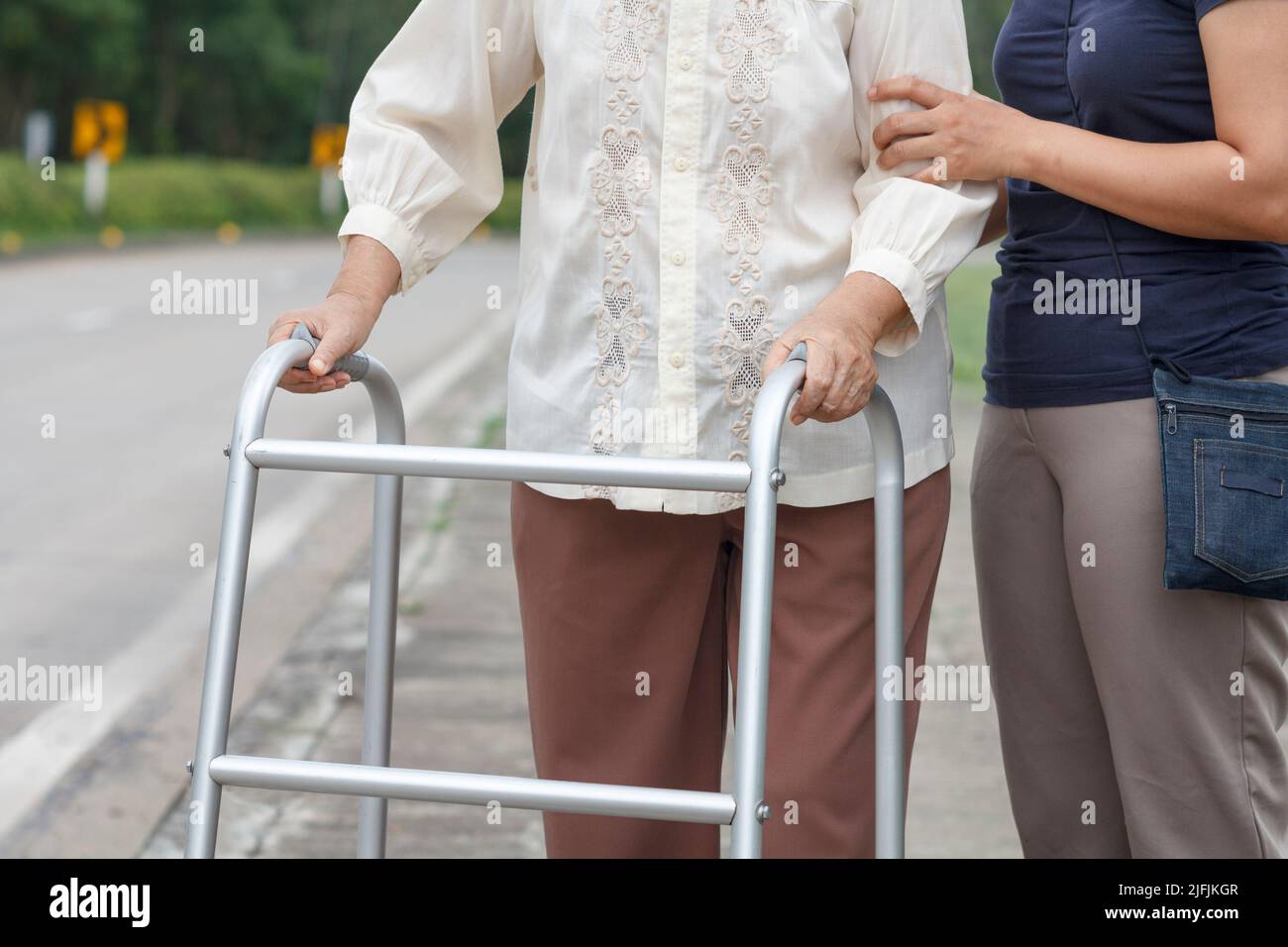 senior woman using a walker cross street Stock Photo - Alamy