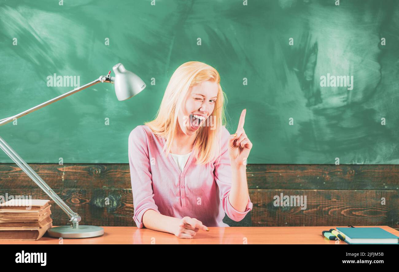 Female student winking and having fun. Funny college student pointing ...