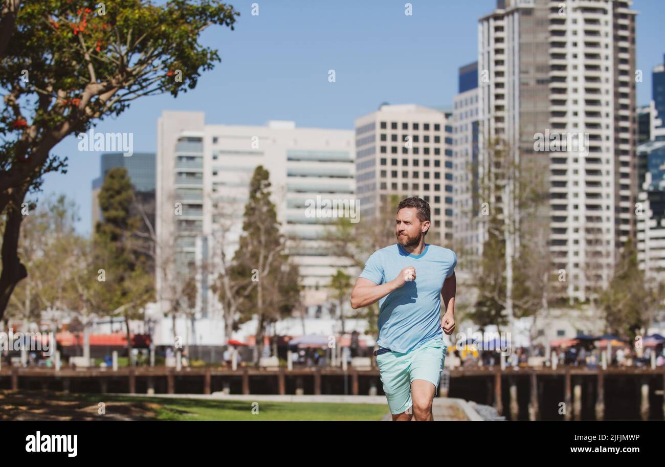 Full length of healthy man running and sprinting outdoors. Male runner ...