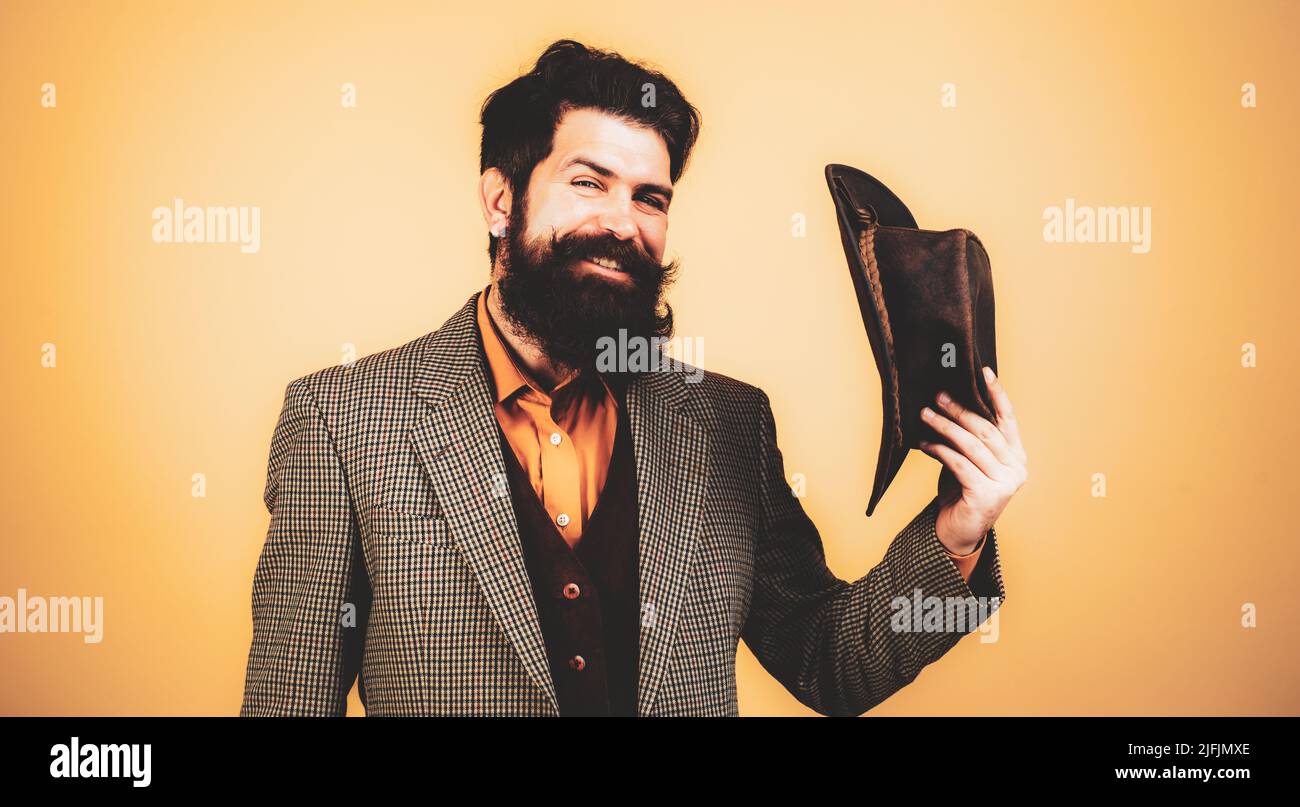 Cheerful smiling gentleman takes off hat in salutation isolated at ...