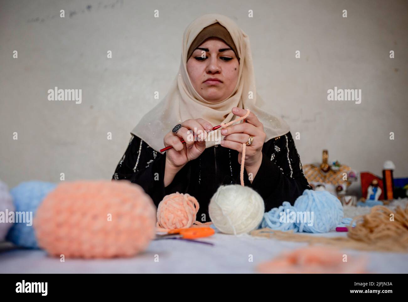 Gaza, Palestine. 02nd July, 2022. A Palestinian woman knits a doll in a ...