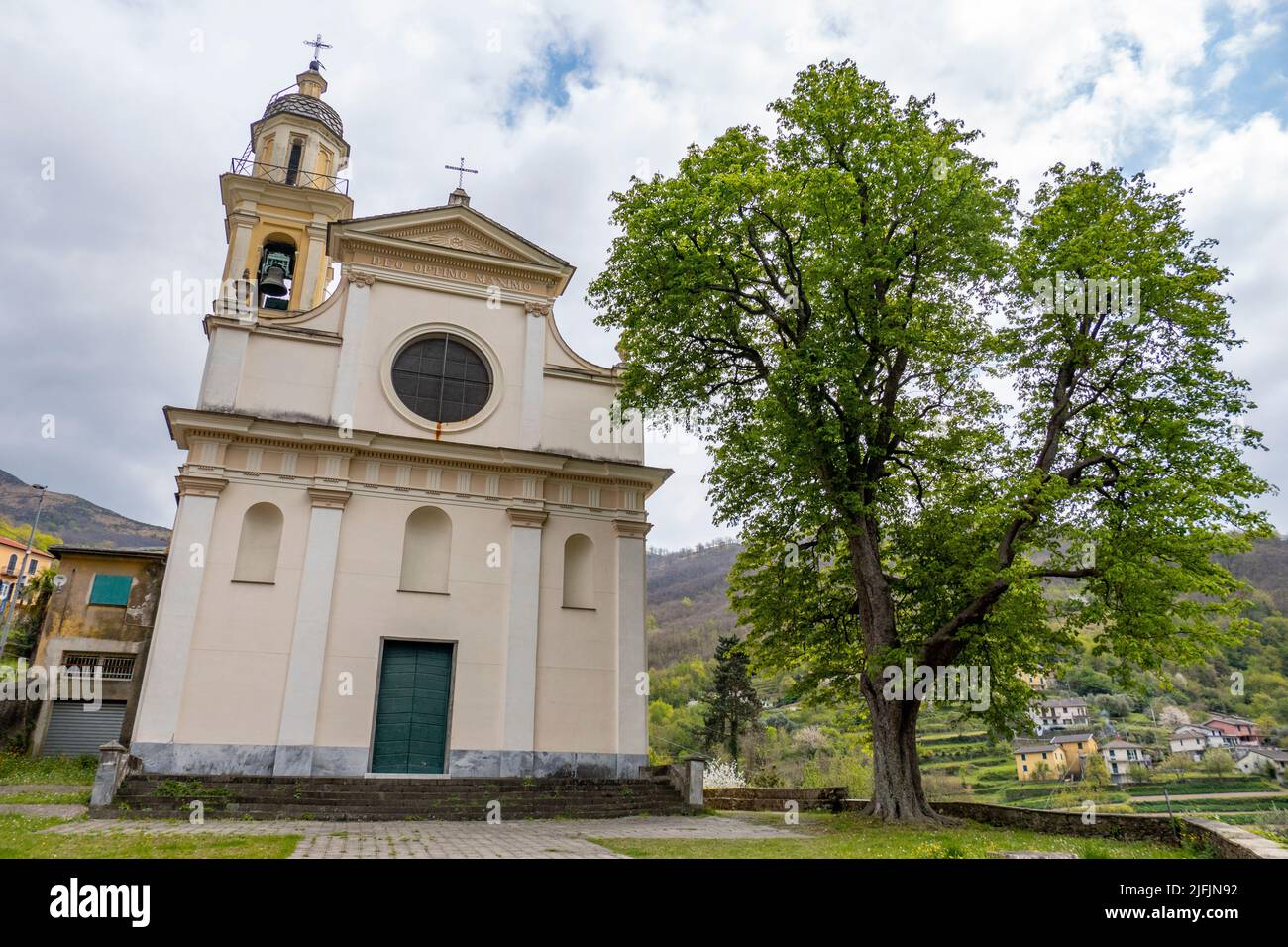 A low angle shot of catholic church in background of mountains in ...