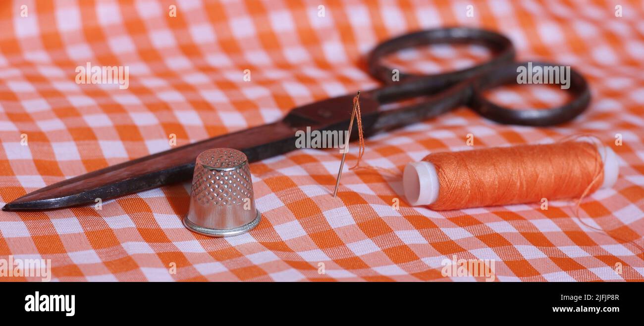 Orange and White Checkered Fabric With Thimble and Spool of Orange ...