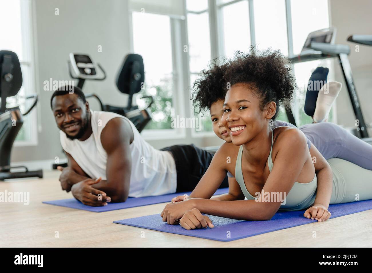 Black family teen parent with children exercise activity for healthcare together at fitness ...