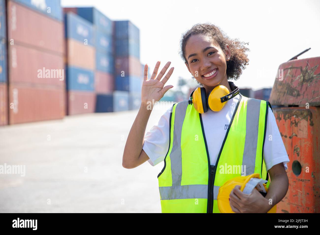 Happy women worker, young teen girl portrait greeting at shipping cargo ...