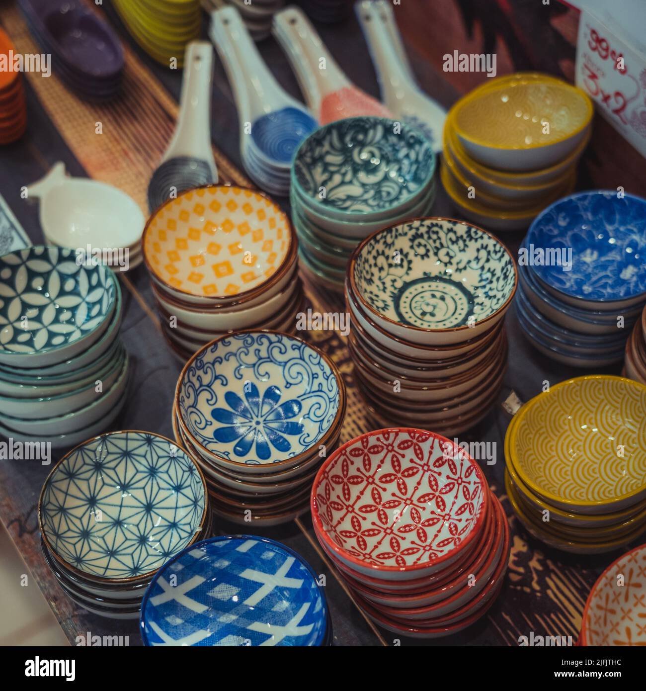 Colorful stacks of decorated bowls and spoon Stock Photo - Alamy