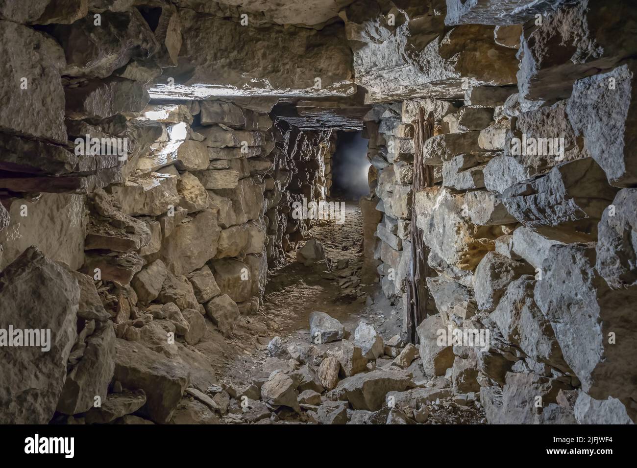 A gallery of old limestone mine illuminated by counter light Stock ...