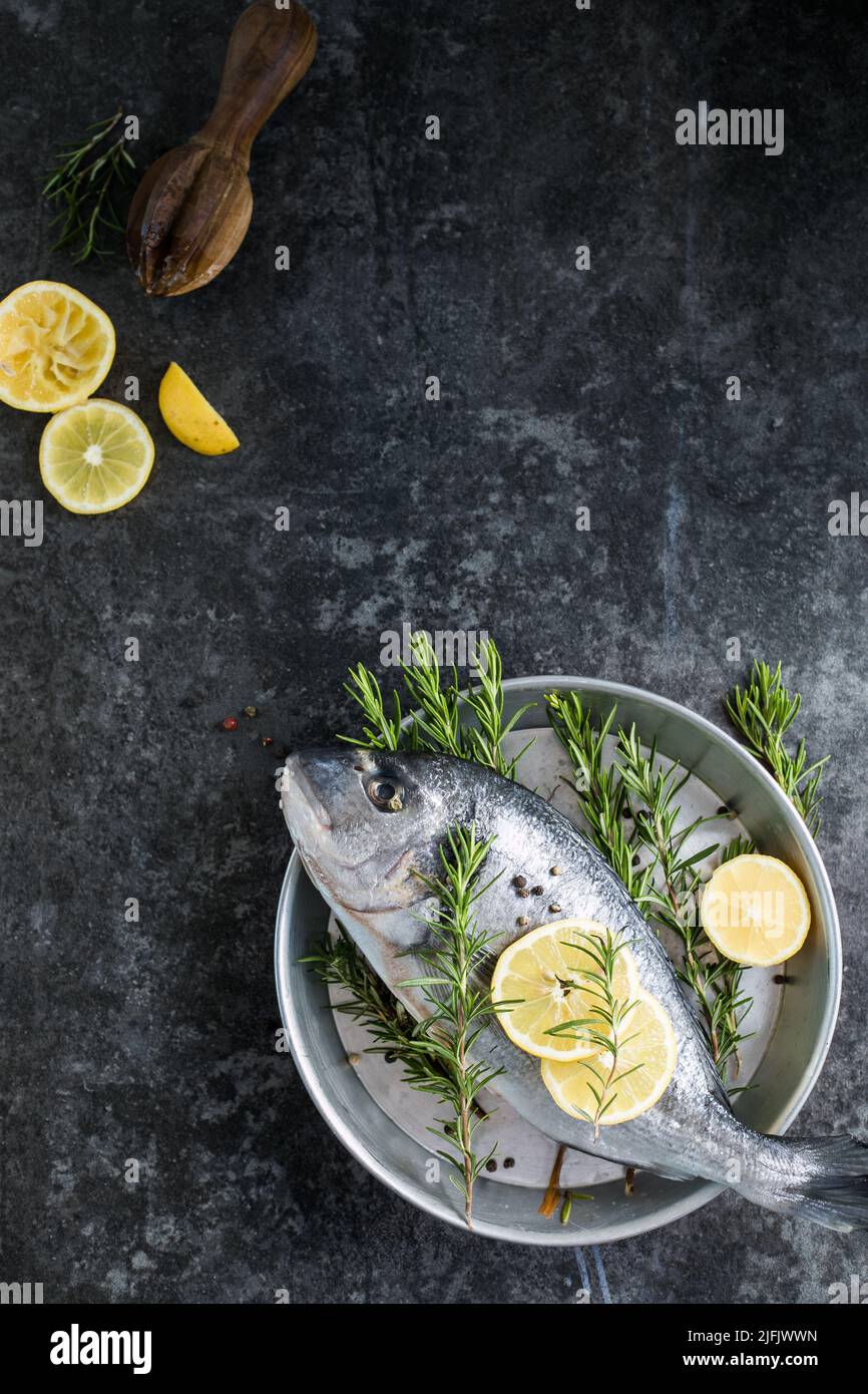 Raw dorado fish with spices. Dorado and ingredients for cooking on a ...