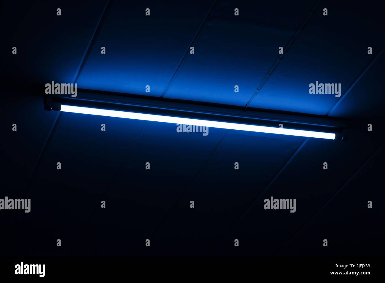 Detail of a fluorescent light tube mounted on a wall Stock Photo - Alamy