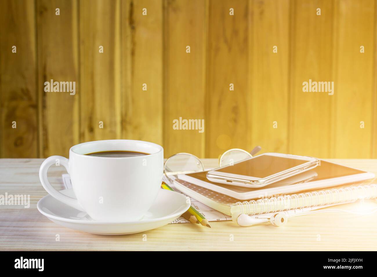 Cup of coffee with note book on wooden table background. Business ...
