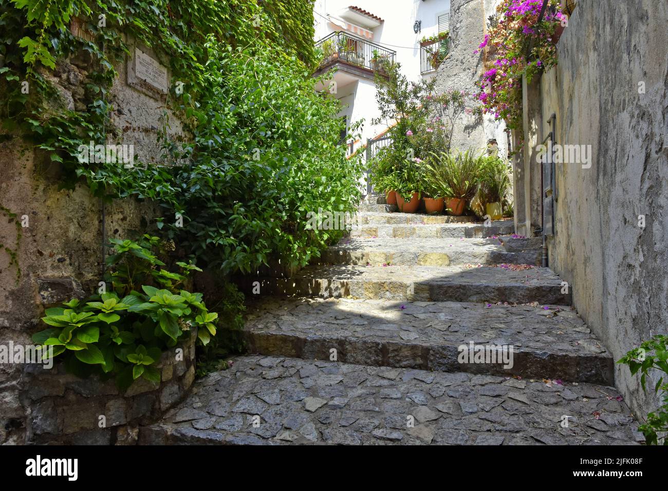 A beautiful shot of a narrow street between old houses in Scalea ...