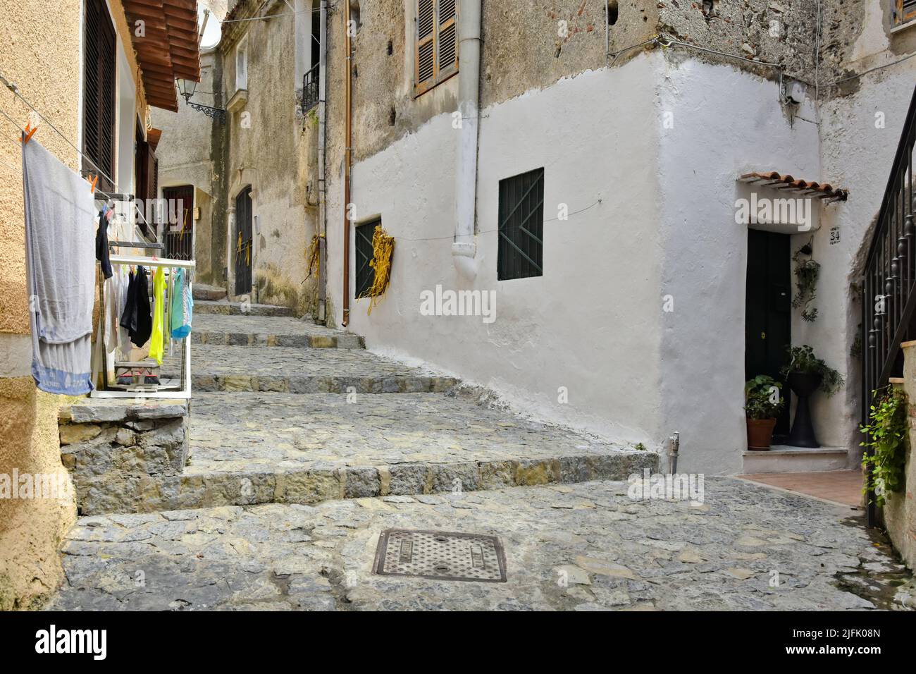 A beautiful shot of a narrow street between old houses in Scalea ...