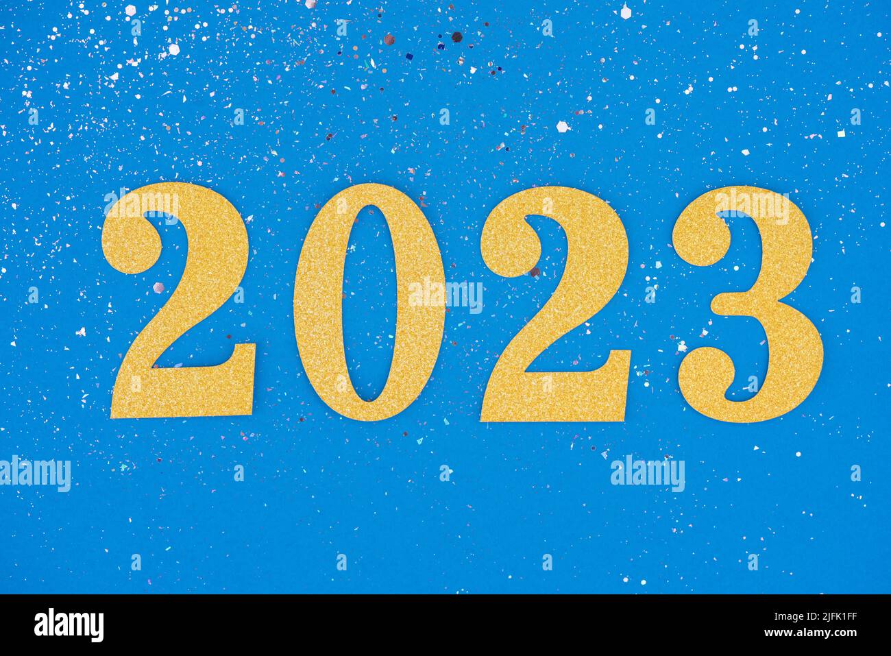 Festive 2023 New Year background with golden sparkles over blue ...