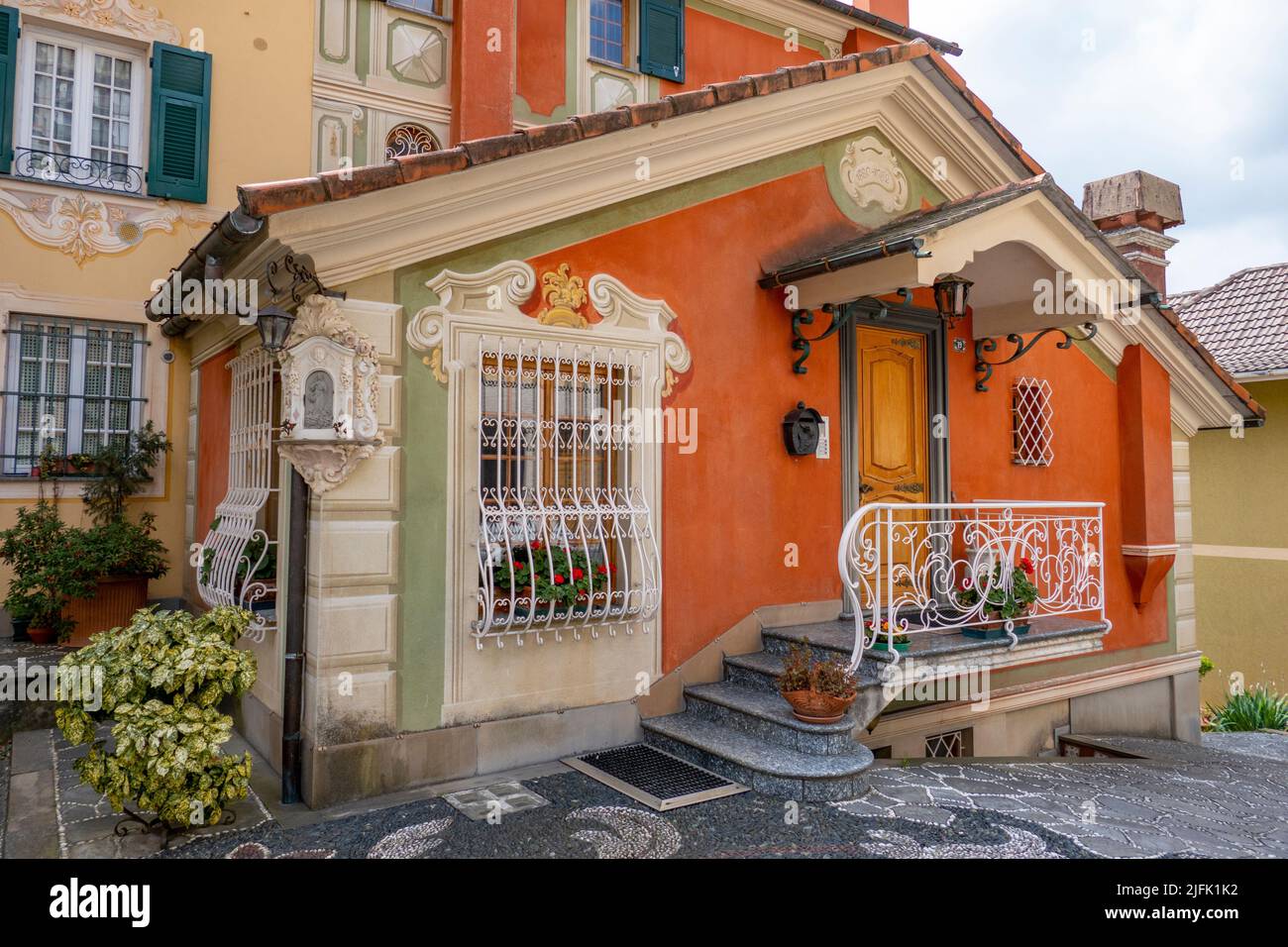 A beautiful shot of an exterior of an old orange house with window bars ...