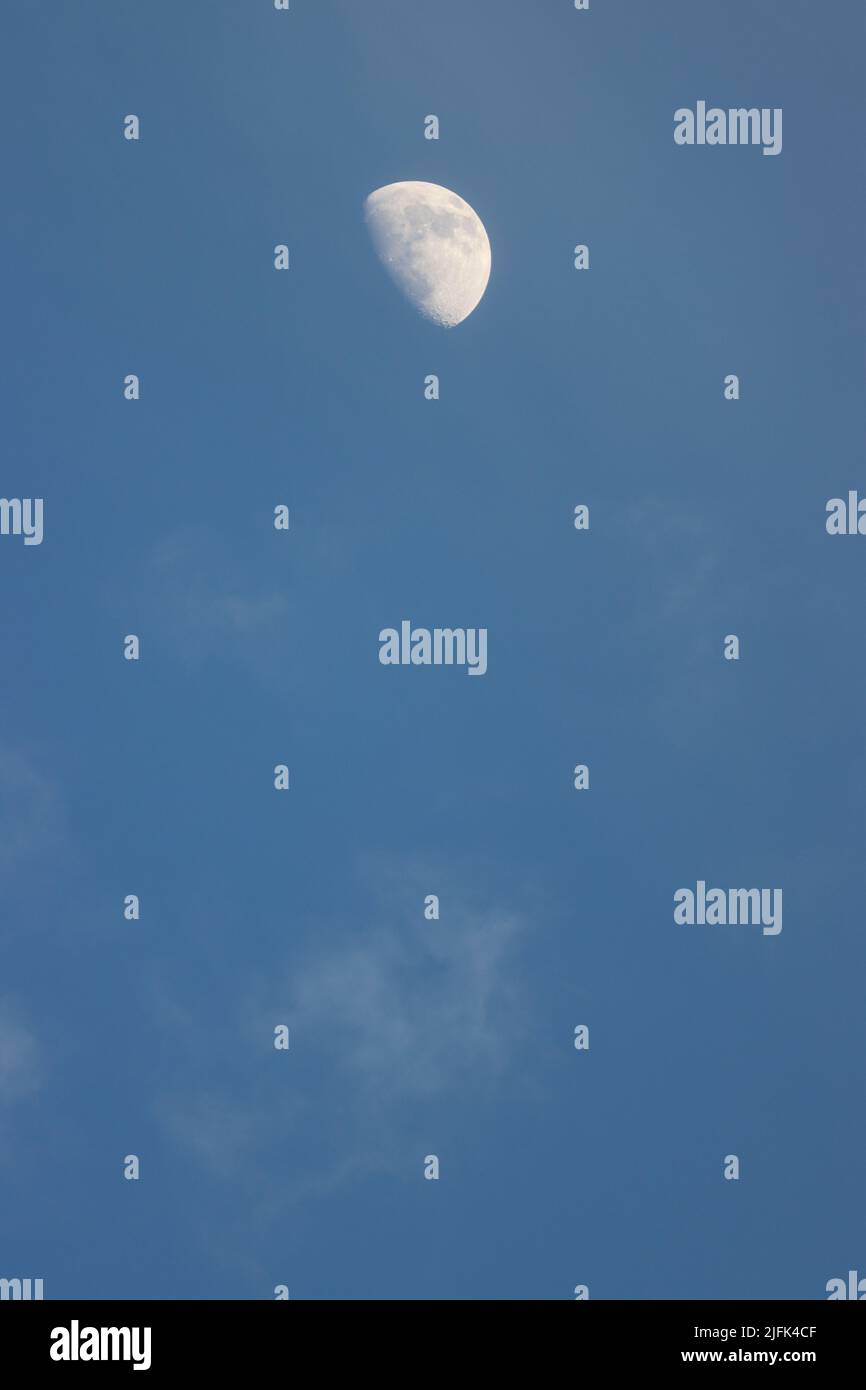 A vertical view of the white lunar eclipse against the blue sky Stock ...