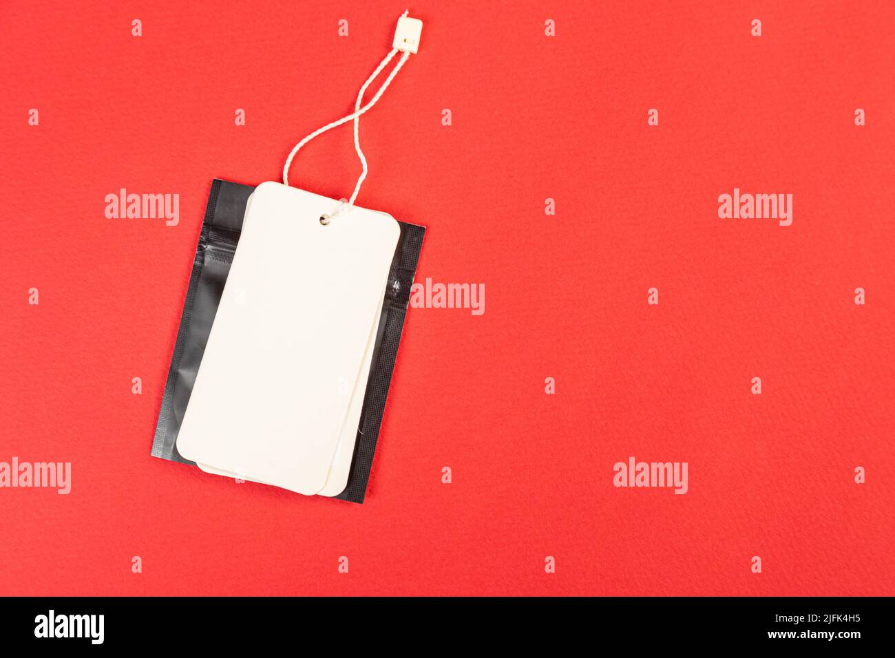 white price tag on a red background, price tag for goods Stock Photo ...