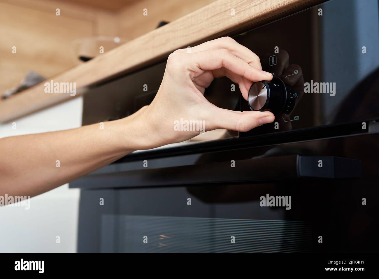 Female hand choose baking program on electric oven control panel, Woman ...