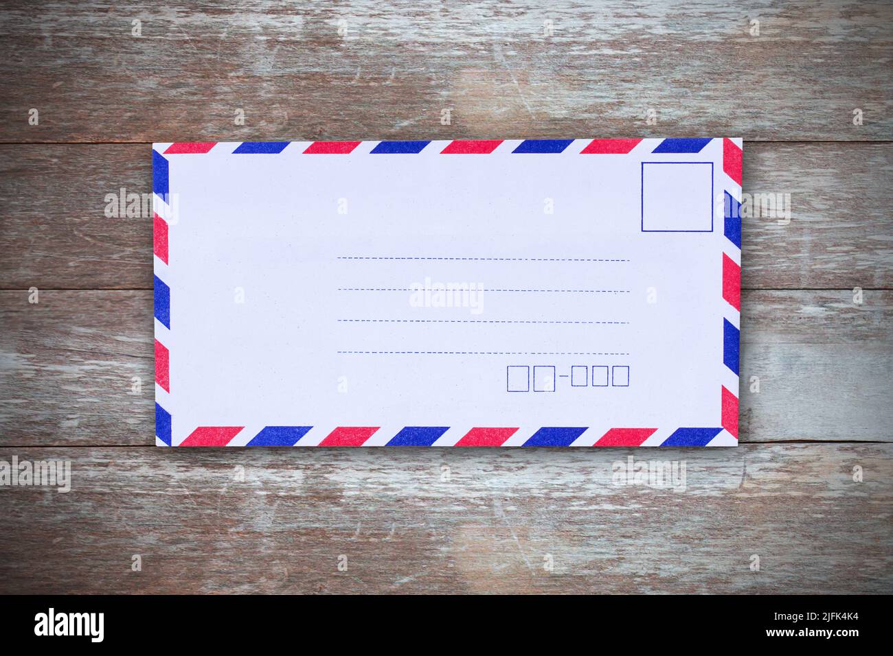 Top view with air mail envelope on the wood table in office work place ...
