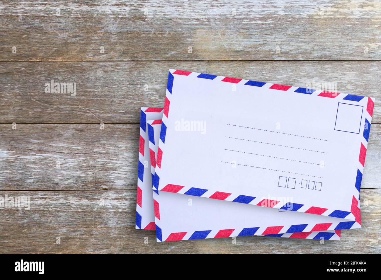 Top view with air mail envelope on the wood table in office work place ...