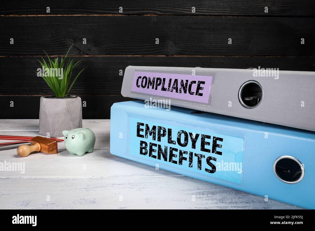 EMPLOYEE BENEFITS and COMPLIANCE. Document binders, folders on a wooden ...