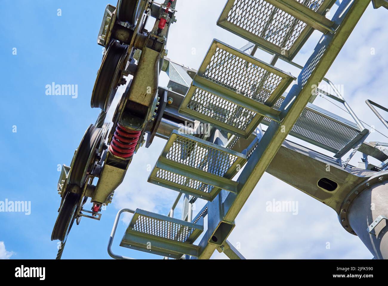 Open cable car line. Metal cable and moving rollers on platform for ...