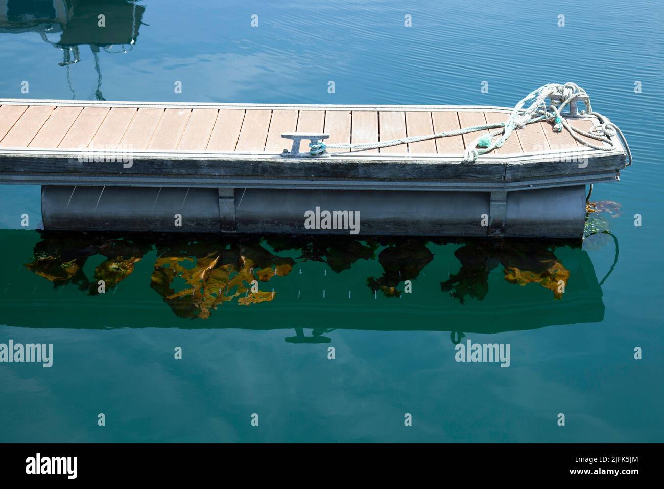 Dock With Algae On Turquoise Sea Water Stock Photo - Alamy