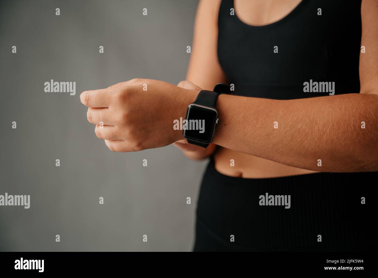 Close up young Caucasian female adjusting her smart watch Stock Photo ...