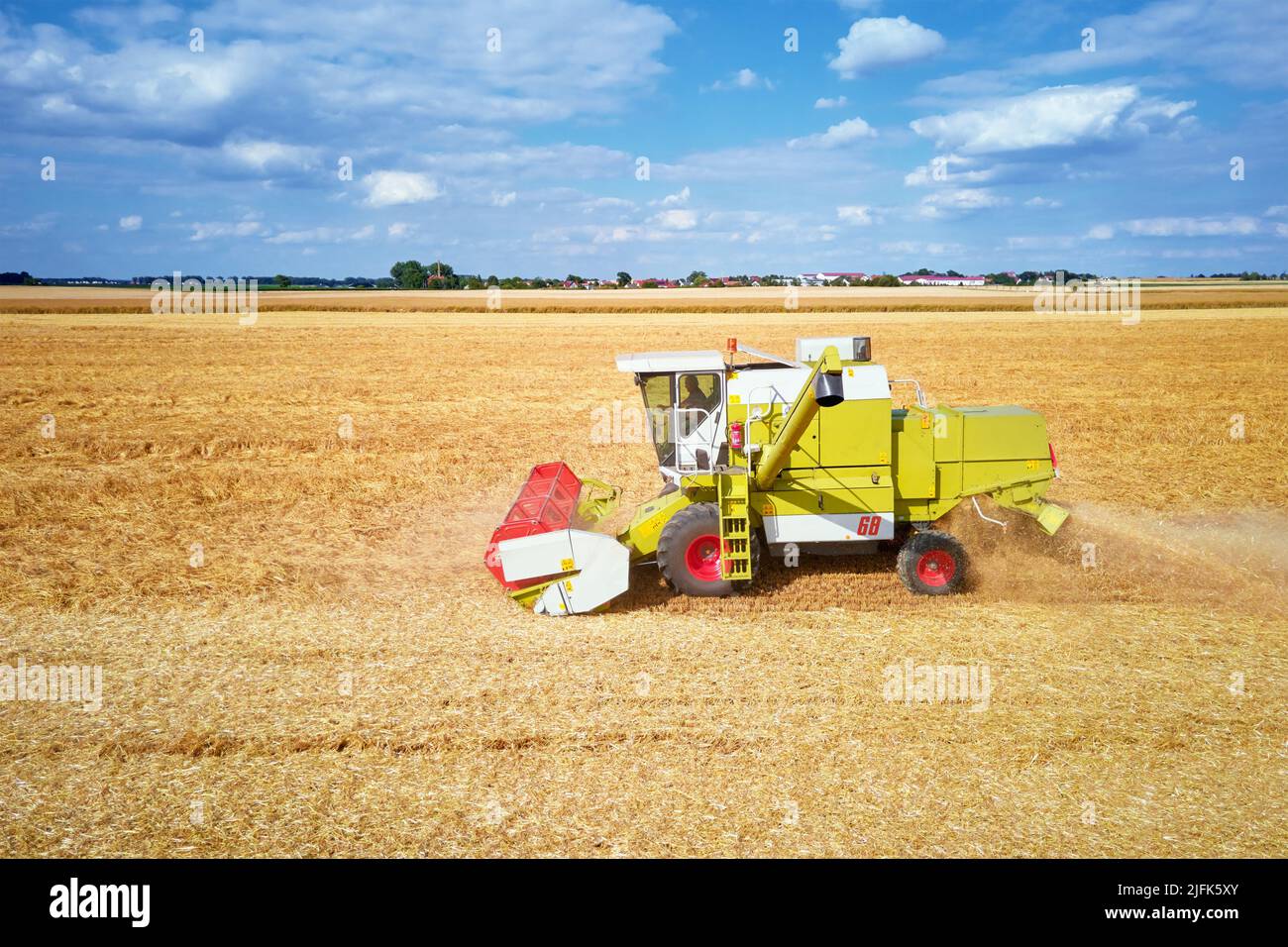 Combine harvester collecting golden wheat field, Harvesting machine ...