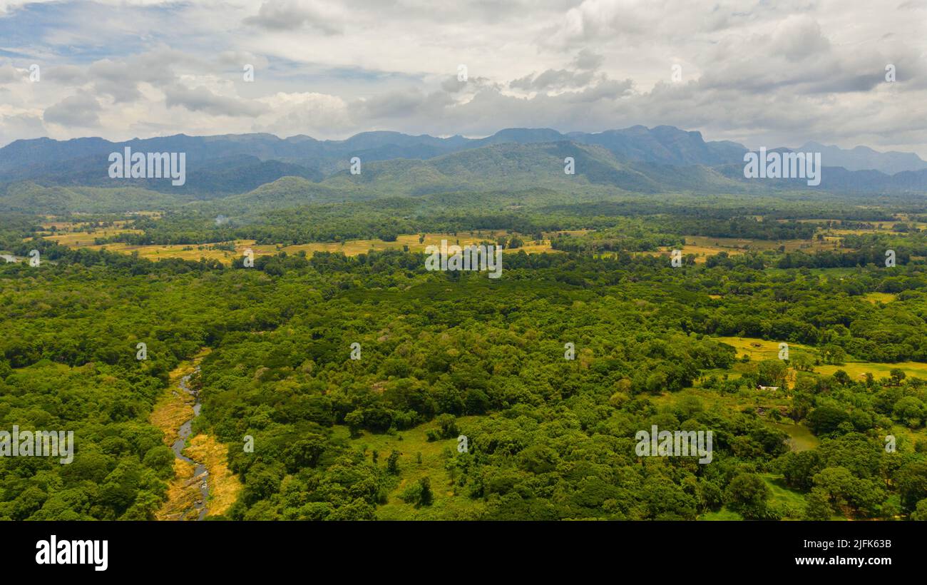 Rustic landscape with agricultural lands and farms among mountains and ...