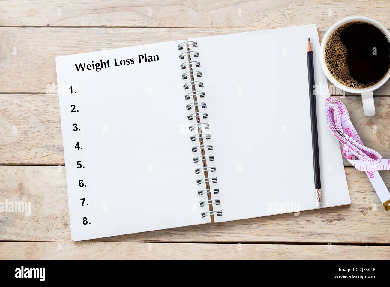 Weight loss program written on book with black listing, planning ...