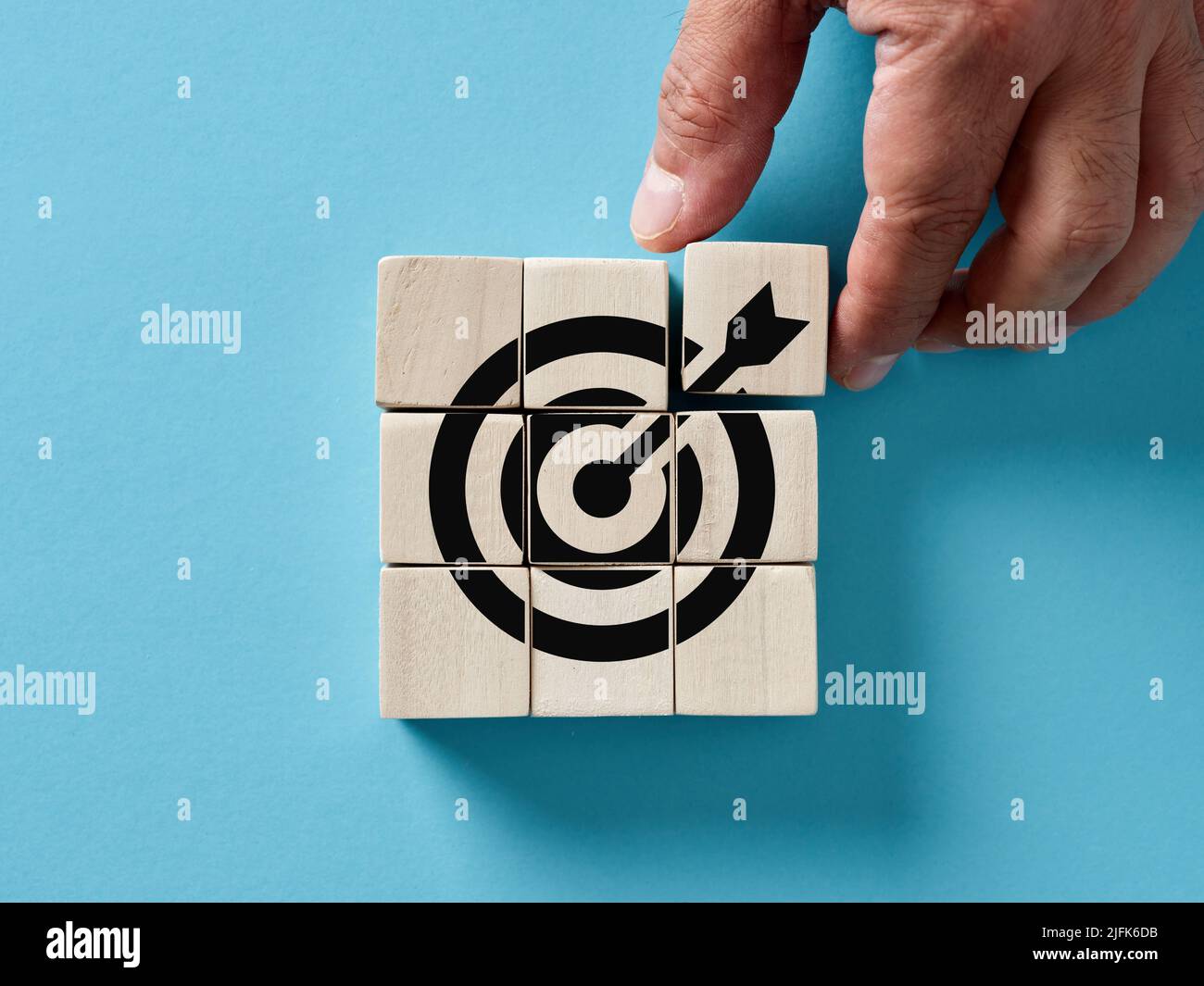 Male hand arranging wooden cubes with target icon. Business strategy ...
