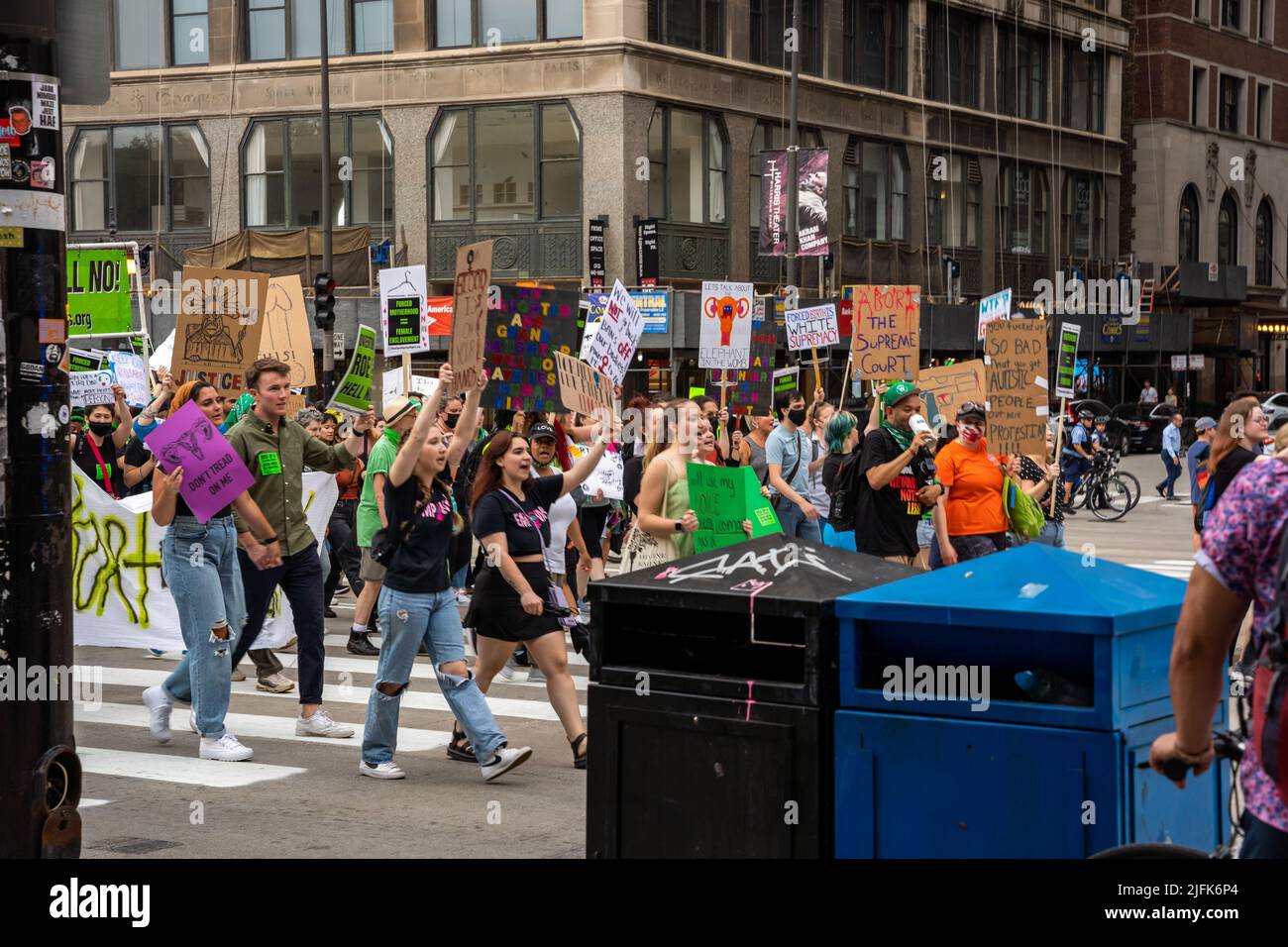Protesters holding signs My Body My Choice, Ban bombs not Bodies ...