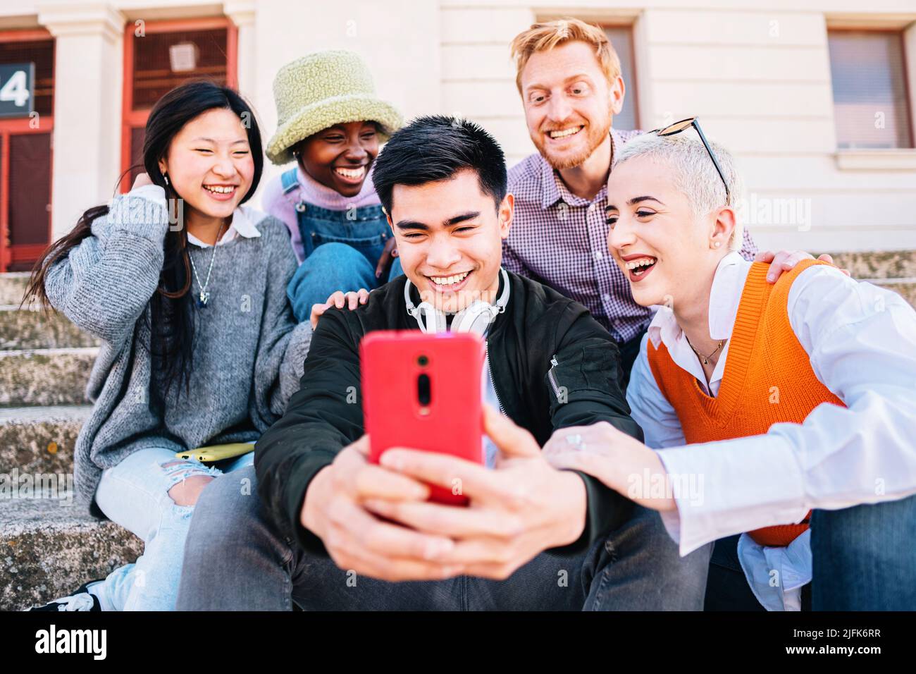 happy young group of smiling friends, having fun together using ...