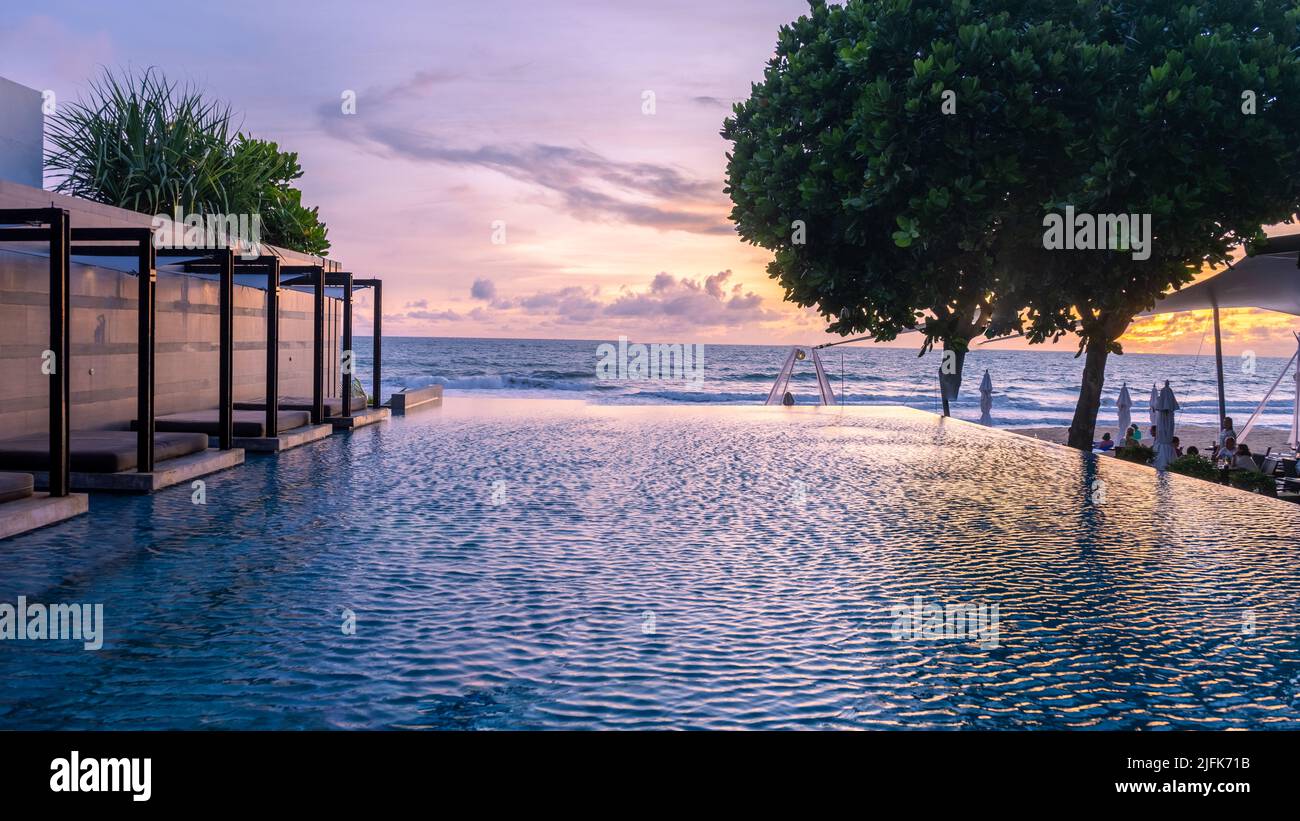 Modern Infinity pool at the beach. luxury infinity pool with beach beds ...