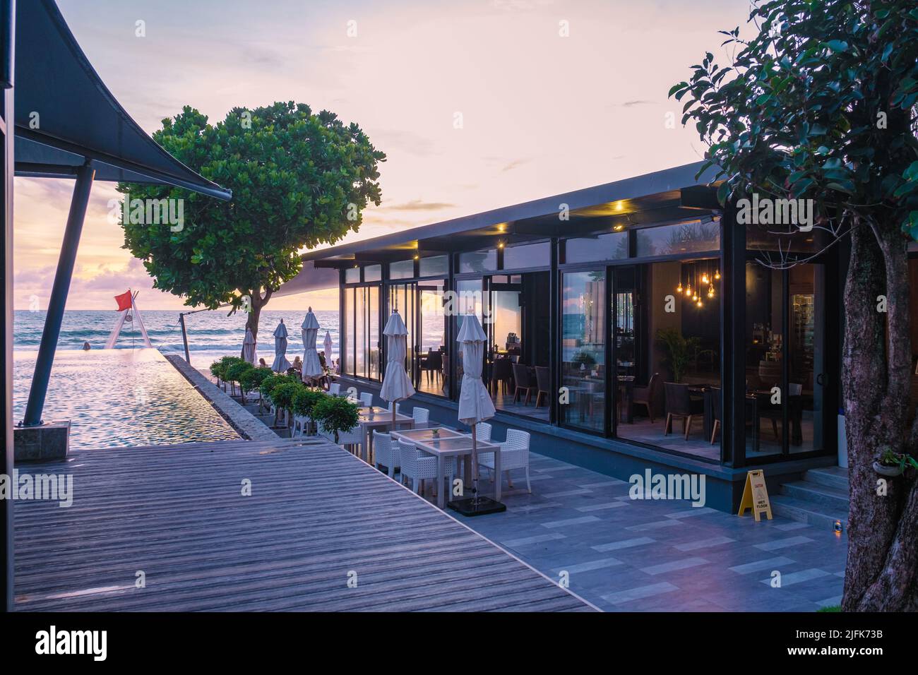 Modern Infinity pool at the beach. luxury infinity pool with beach beds ...