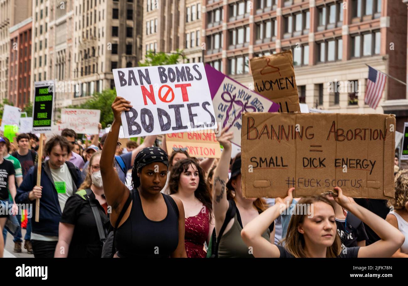 Protesters holding signs My Body My Choice, Ban bombs not Bodies ...